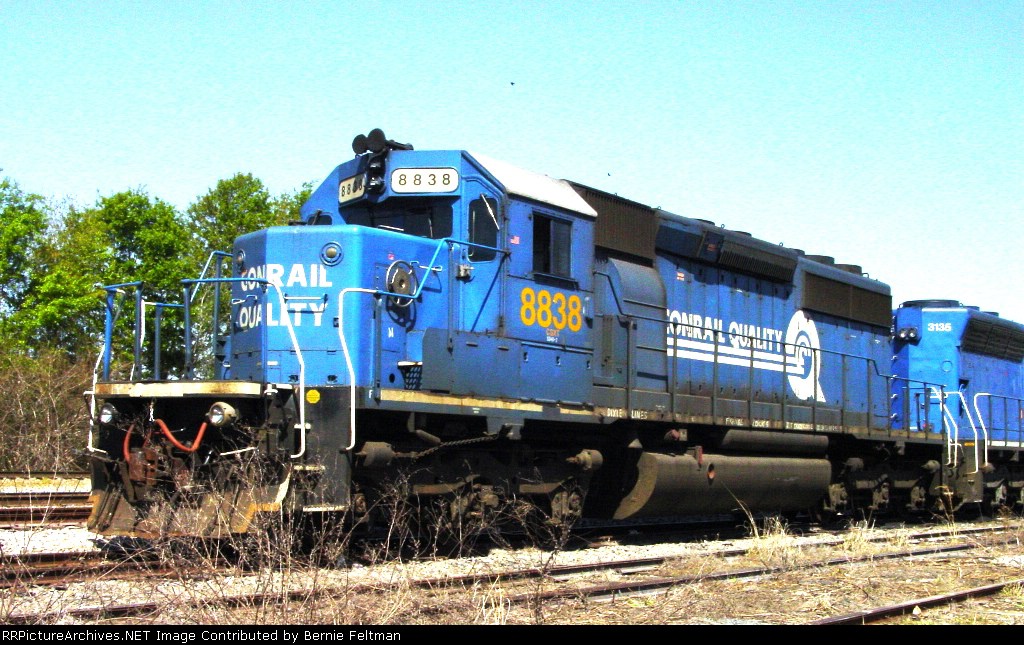 CSX 8838 (SD40-2) in Conrail Quality paint scheme, with "Dixie Lines" rubbed in grime above ...